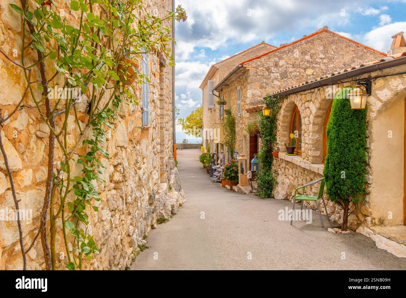 A charming and narrow alley of shops and stone buildings leading to the ...
