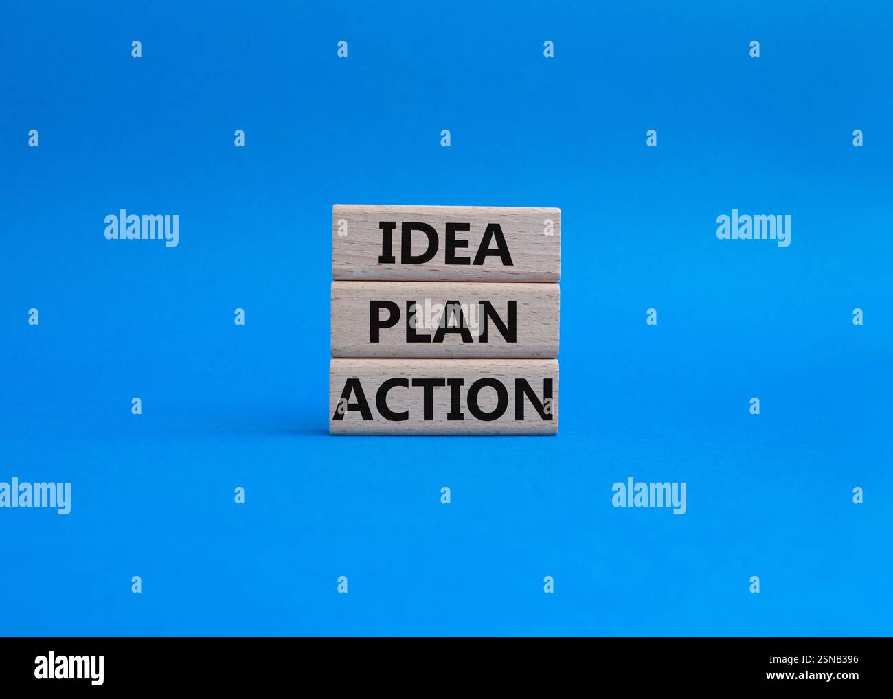 Idea Plan Action symbol. Wooden blocks with words Idea Plan Action. Beautiful blue background ...
