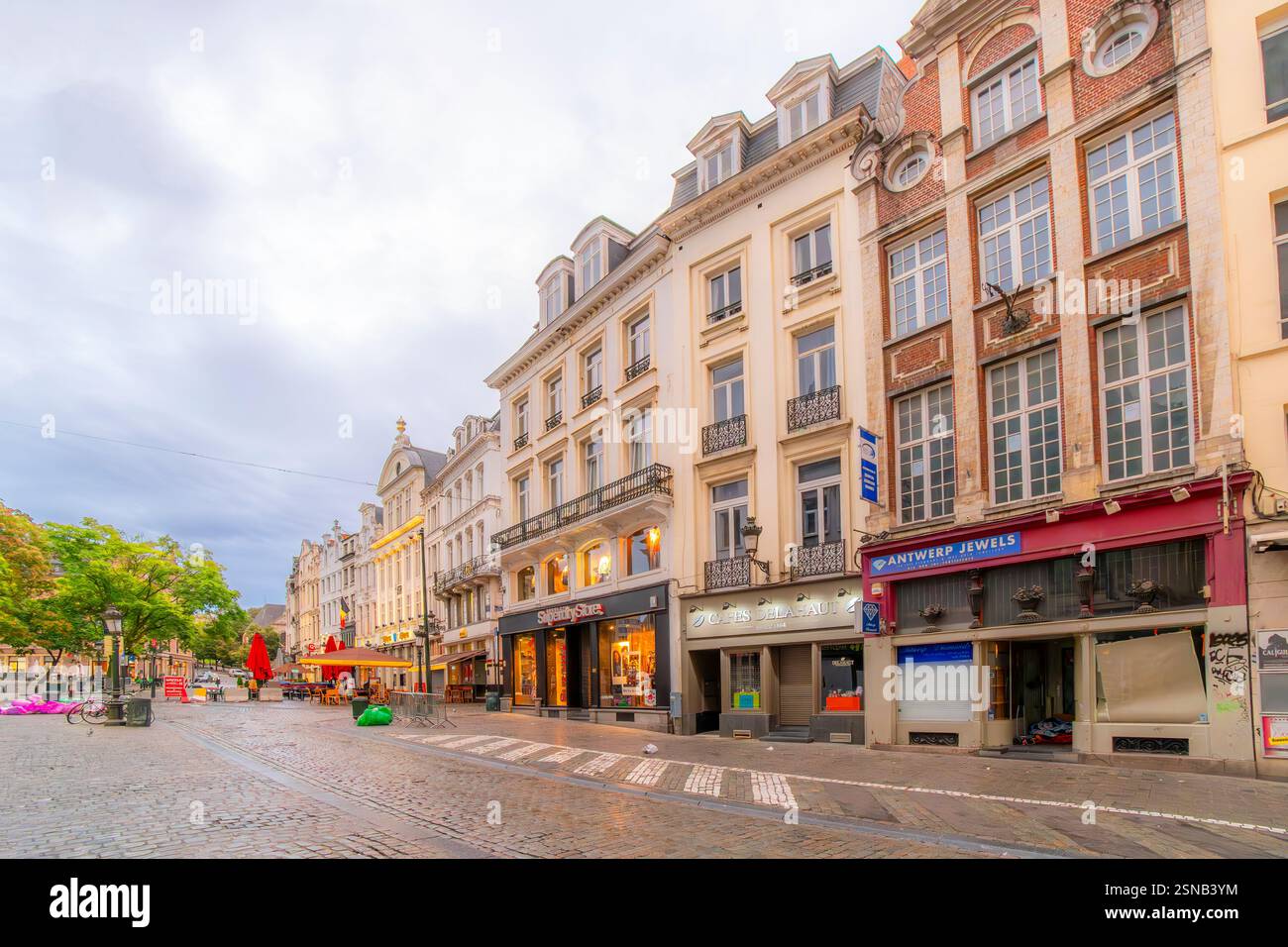 A picturesque street of shops and sidewalk cafes near the Grand Place ...