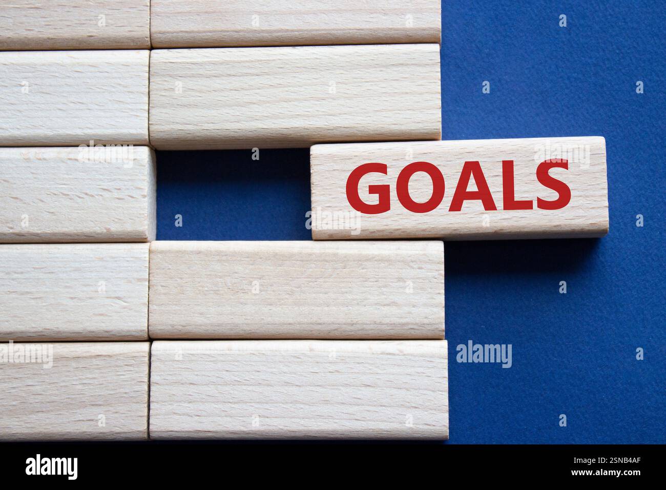 Goals symbol. Concept word Goals on wooden blocks. Beautiful deep blue ...