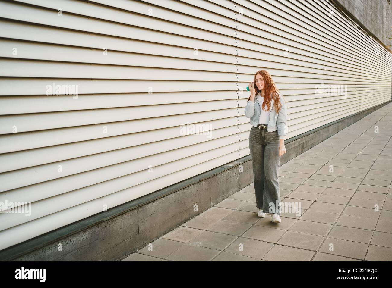 A relaxed and informal street style portrait of a woman captured in an ...
