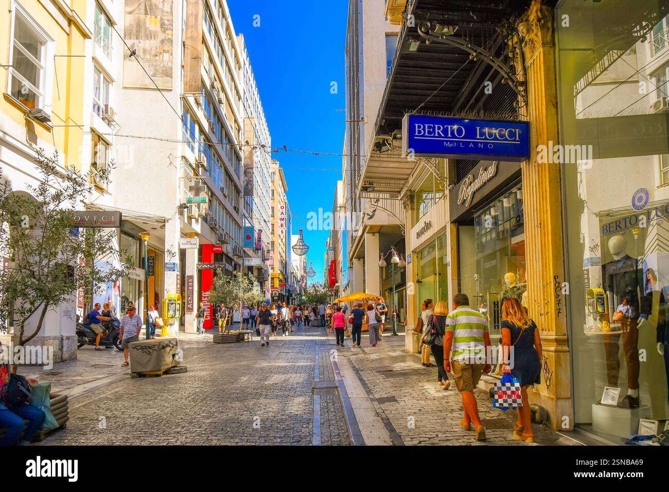 Tourists and local Greeks sightsee and shop along Ernou Street, the ...