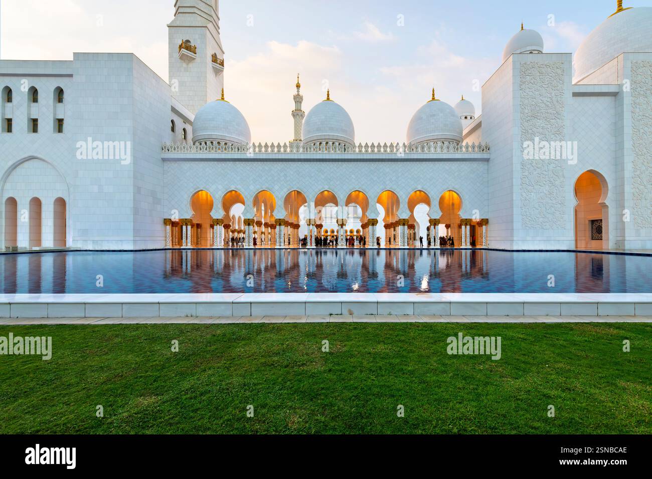 Illuminated interior seen through keyhole arches below Arabic domes and ...
