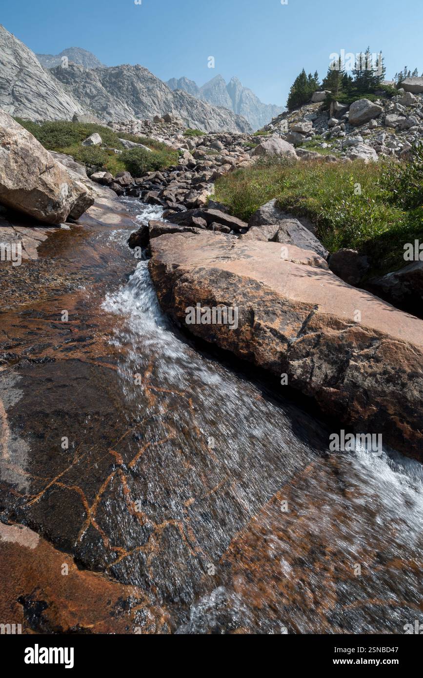 Stream flowing through a steep meadow in Wyoming's Wind River Range ...