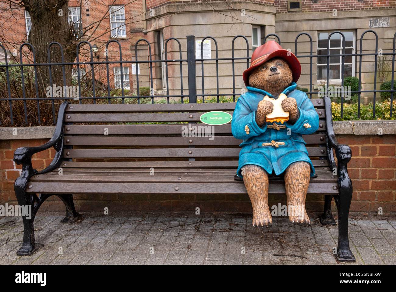 Paddington Bear sitting on a bench eating a marmalade sandwich on Fisherton Street, Salisbury ...