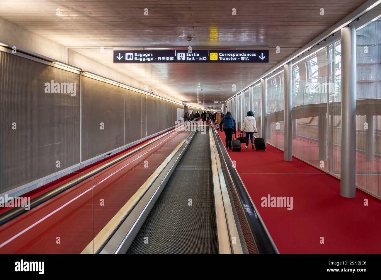 View of a long pedestrian moving walkway with electric people mover or ...