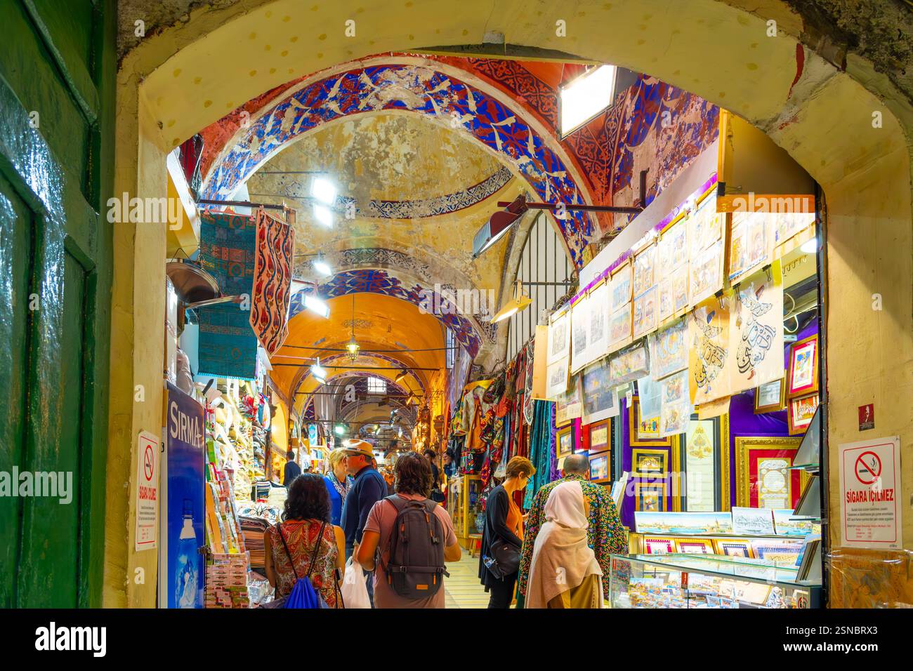 Tourists shop the souvenirs, textiles and gifts in the colorful ...