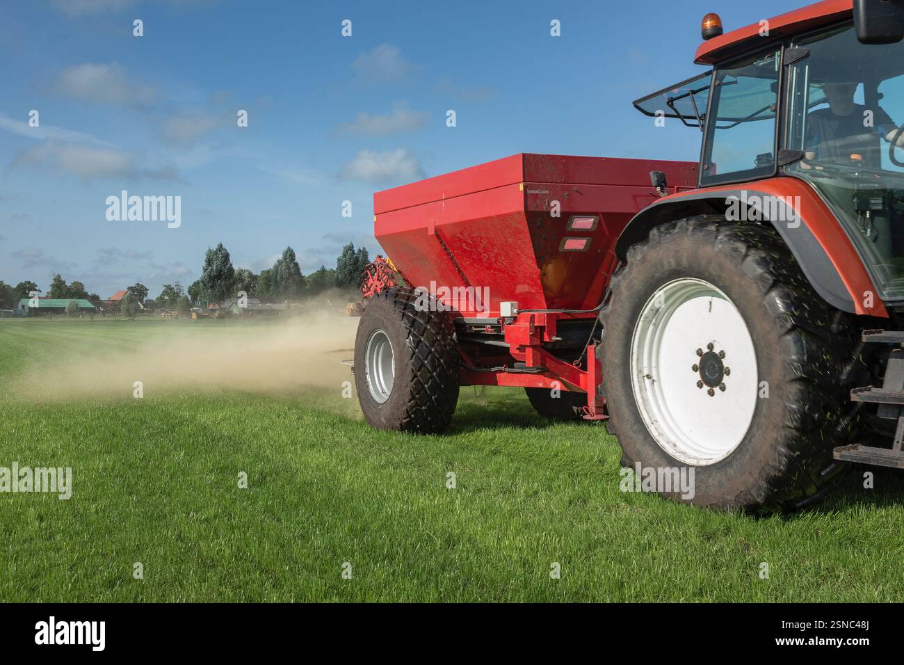 Tractor spraying fertilizer on a field. Fertilizer. Agricultural ...