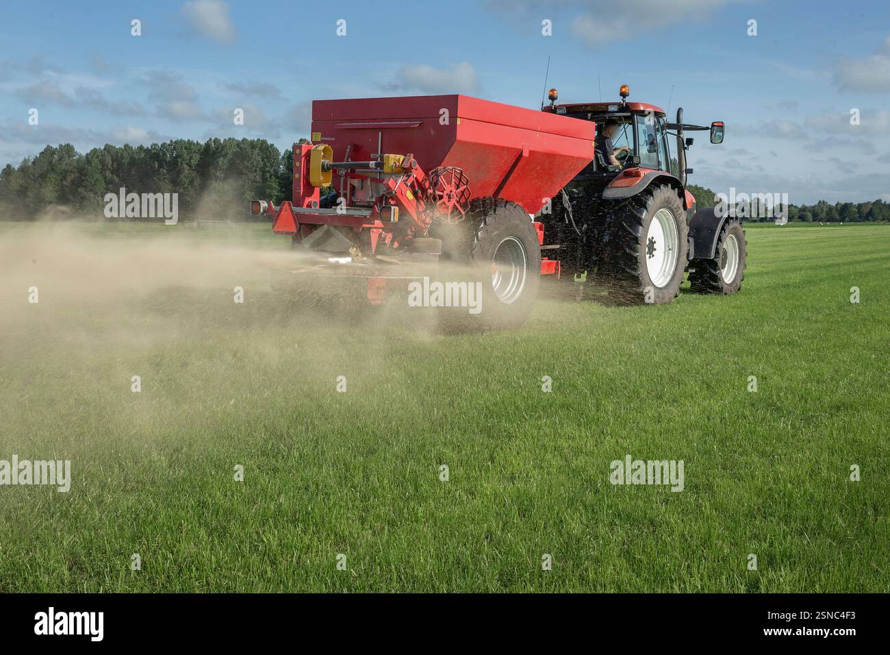 Tractor spraying fertilizer on a field. Fertilizer. Agricultural ...