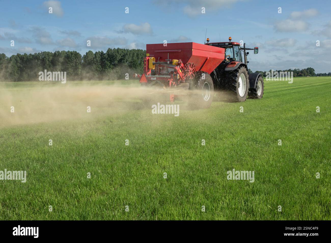 Tractor spraying fertilizer on a field. Fertilizer. Agricultural ...