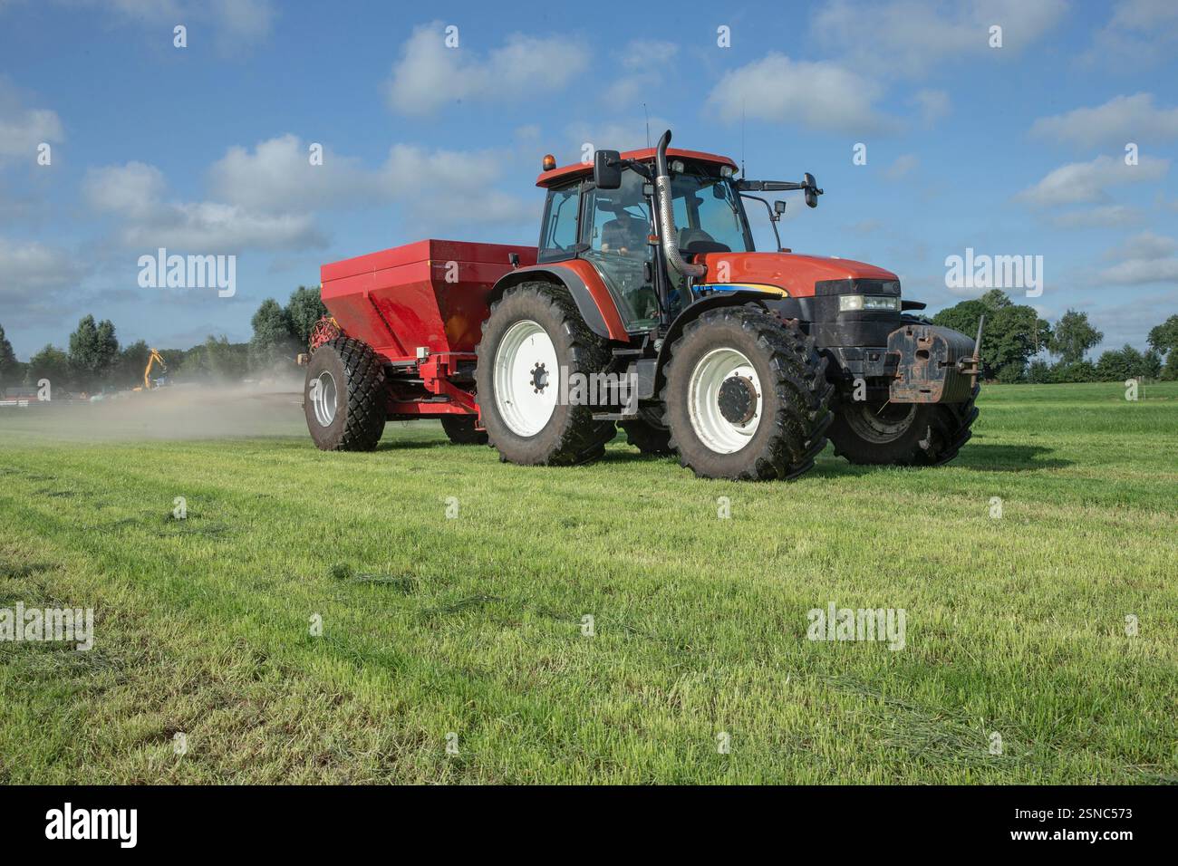 Tractor spraying fertilizer on a field. Fertilizer. Agricultural ...