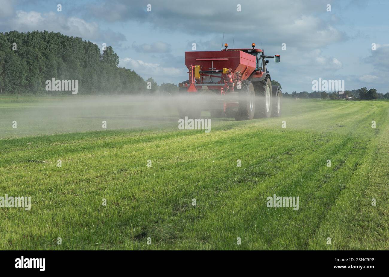 Tractor spraying fertilizer on a field. Fertilizer. Agricultural ...