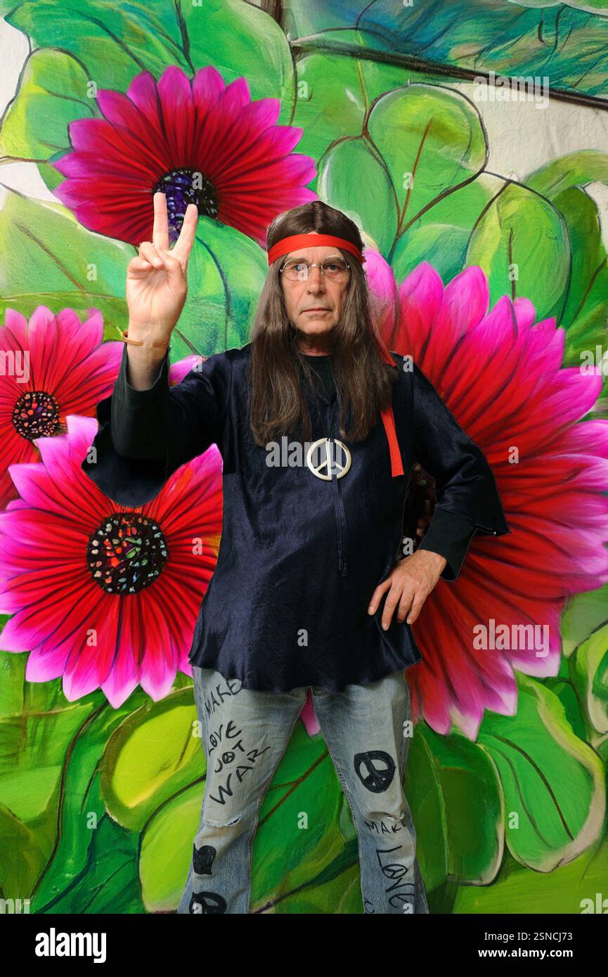 Man wearing retro hippy fancy dress for party Stock Photo - Alamy