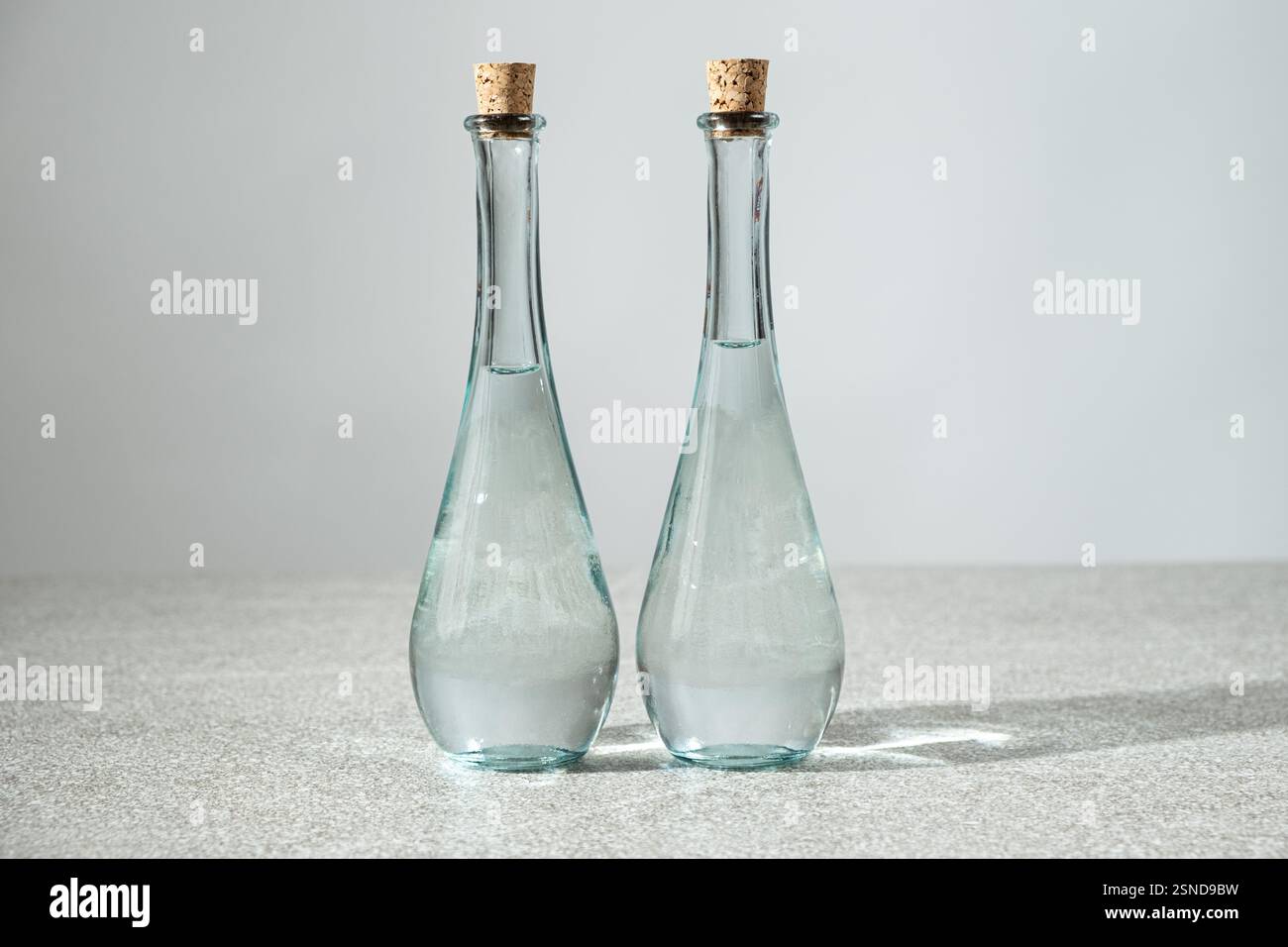 Classic white distilled vinegar in a narrow-spout vinegar bottles with ...