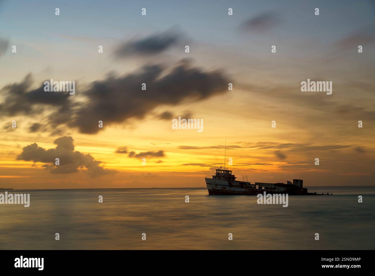 Sunset landscape with a half sunken ship at Maldives, Indian ocean. Big ...