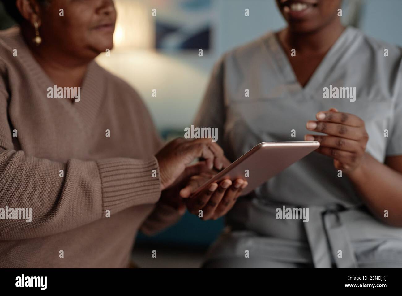 African american caregiver assisting girl hi-res stock photography and ...