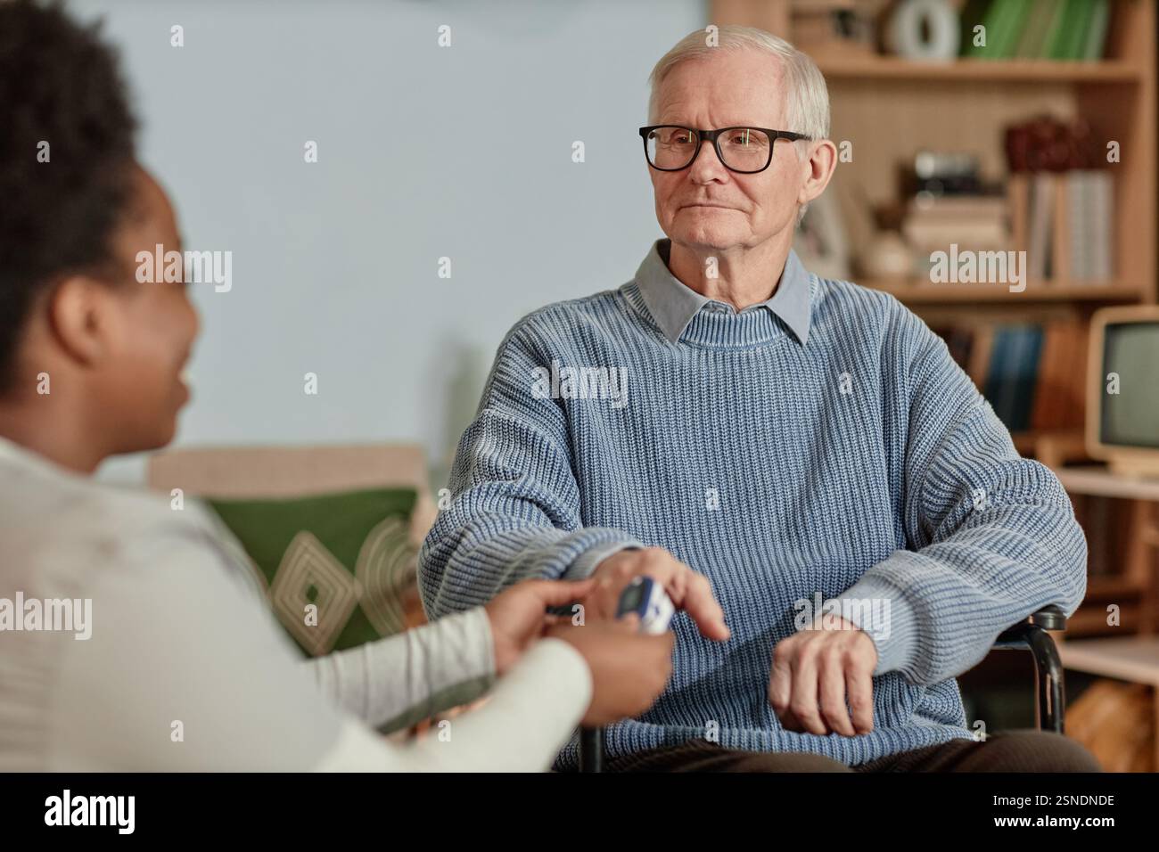 Medium shot of calm elderly man in wheelchair waiting for test results ...