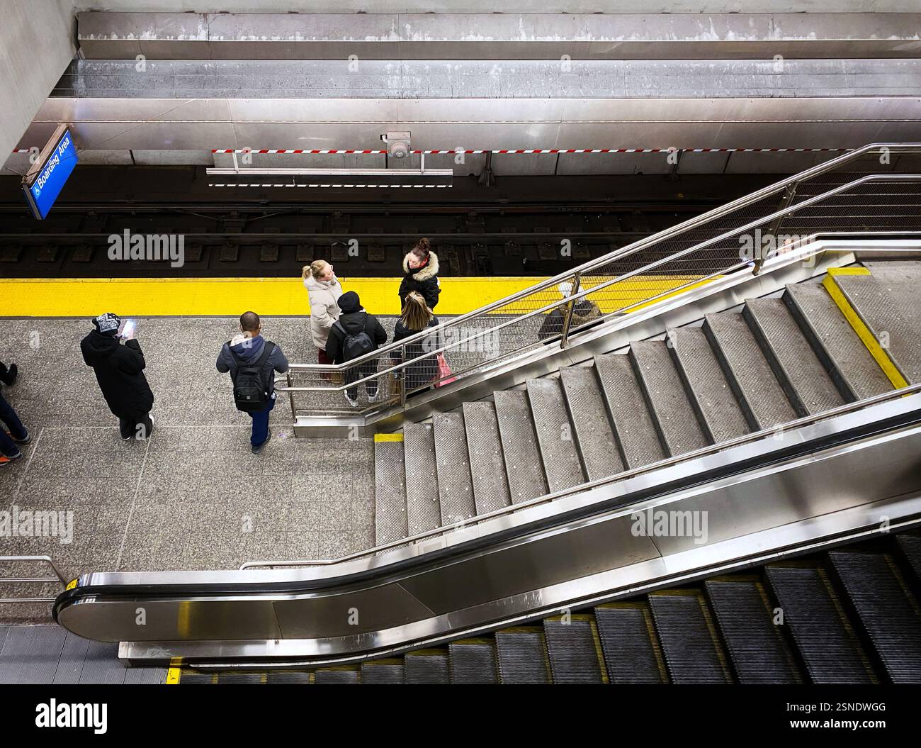 New York City, USA. 13th February, 2025. Commuters stand on the subway ...