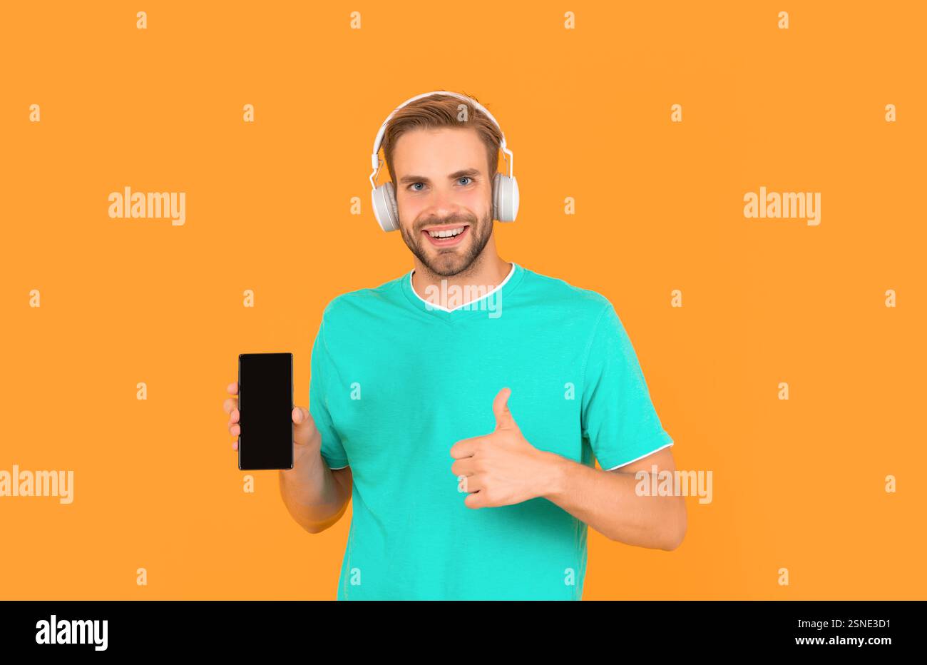 The best phone. Happy guy give thumbs up to mobile phone. Use it to ...