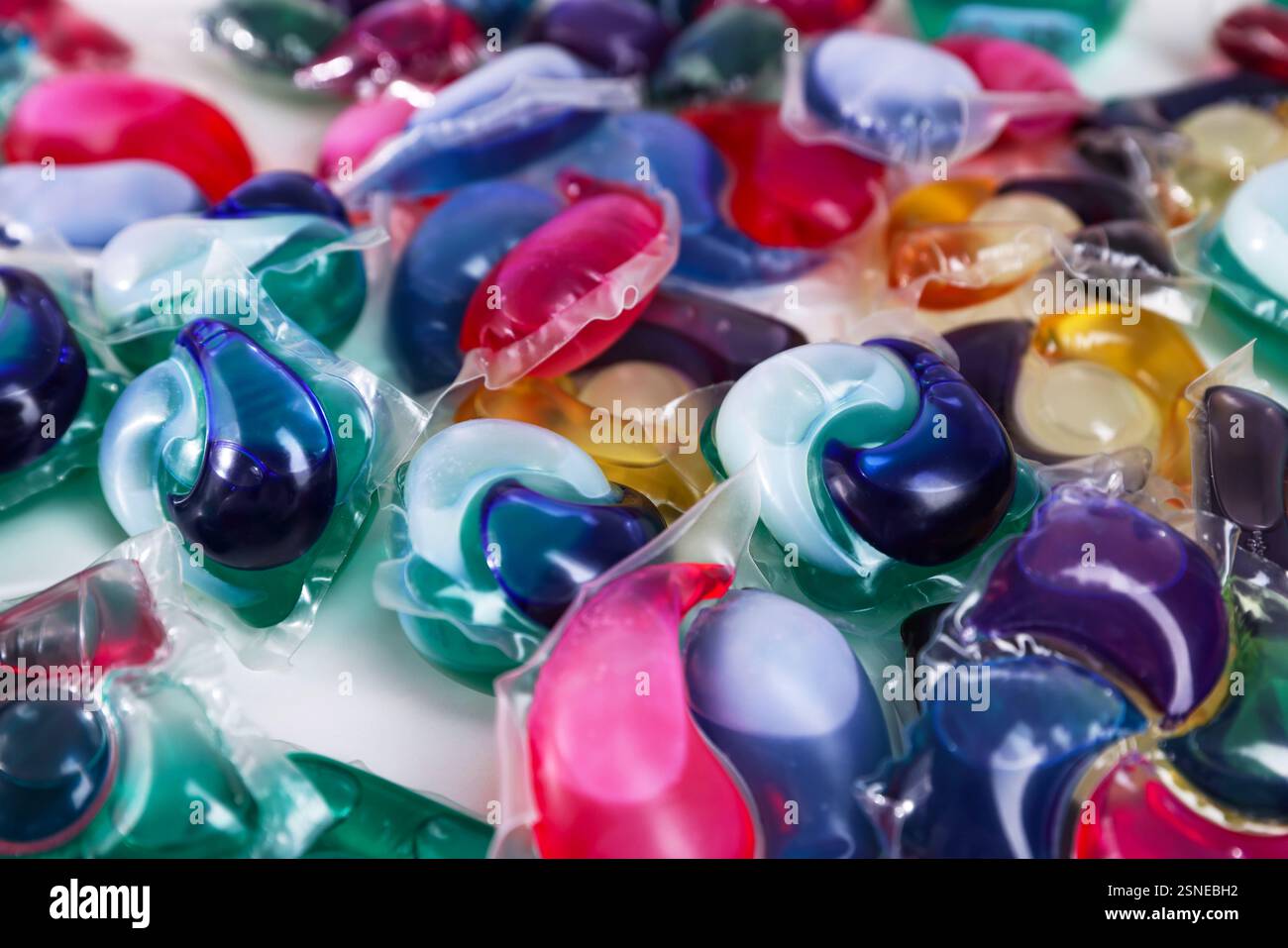 Different laundry detergent capsules on white background, closeup Stock ...