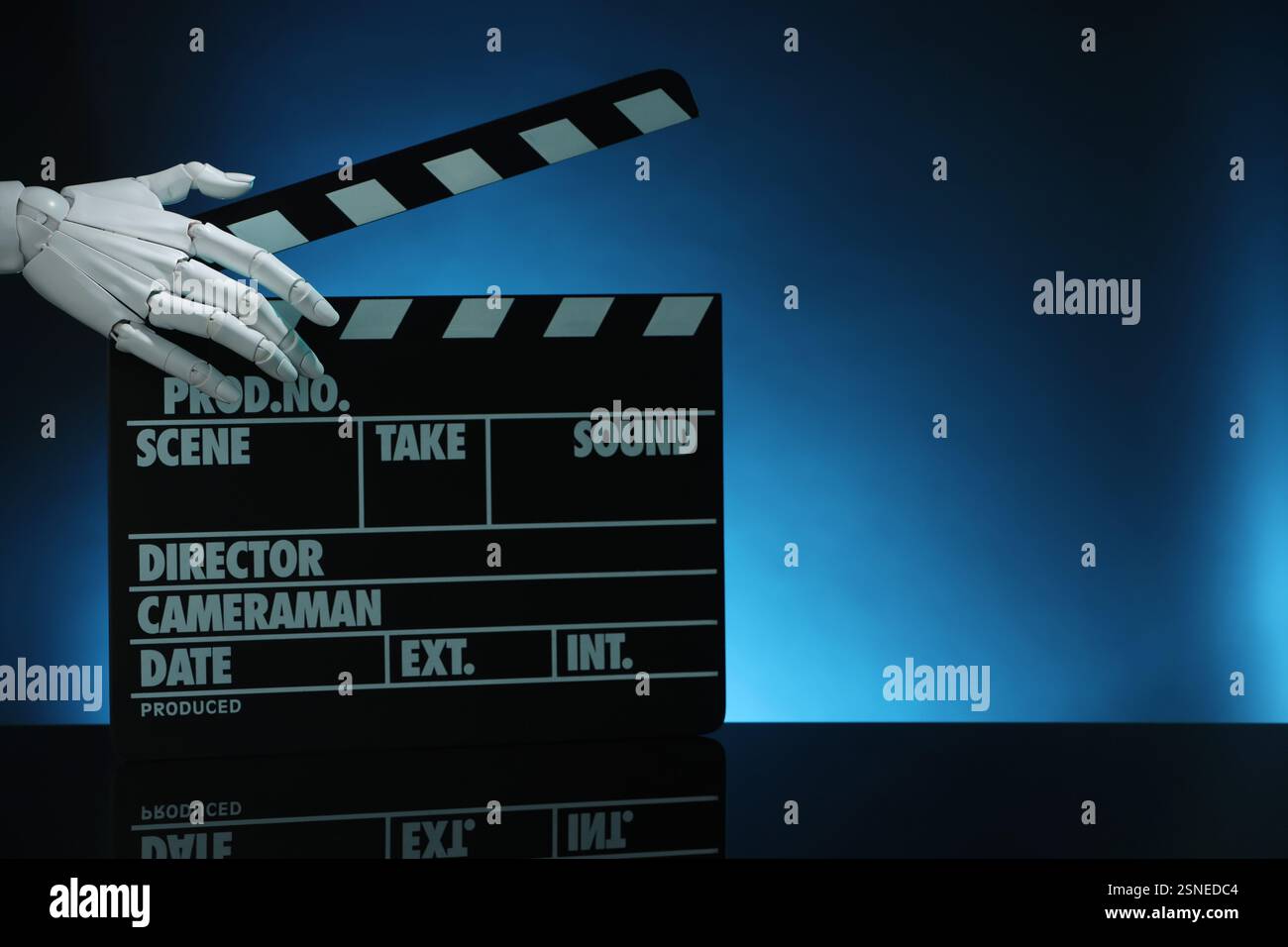 Artificial intelligence. Robot hand with clapper against dark blue ...