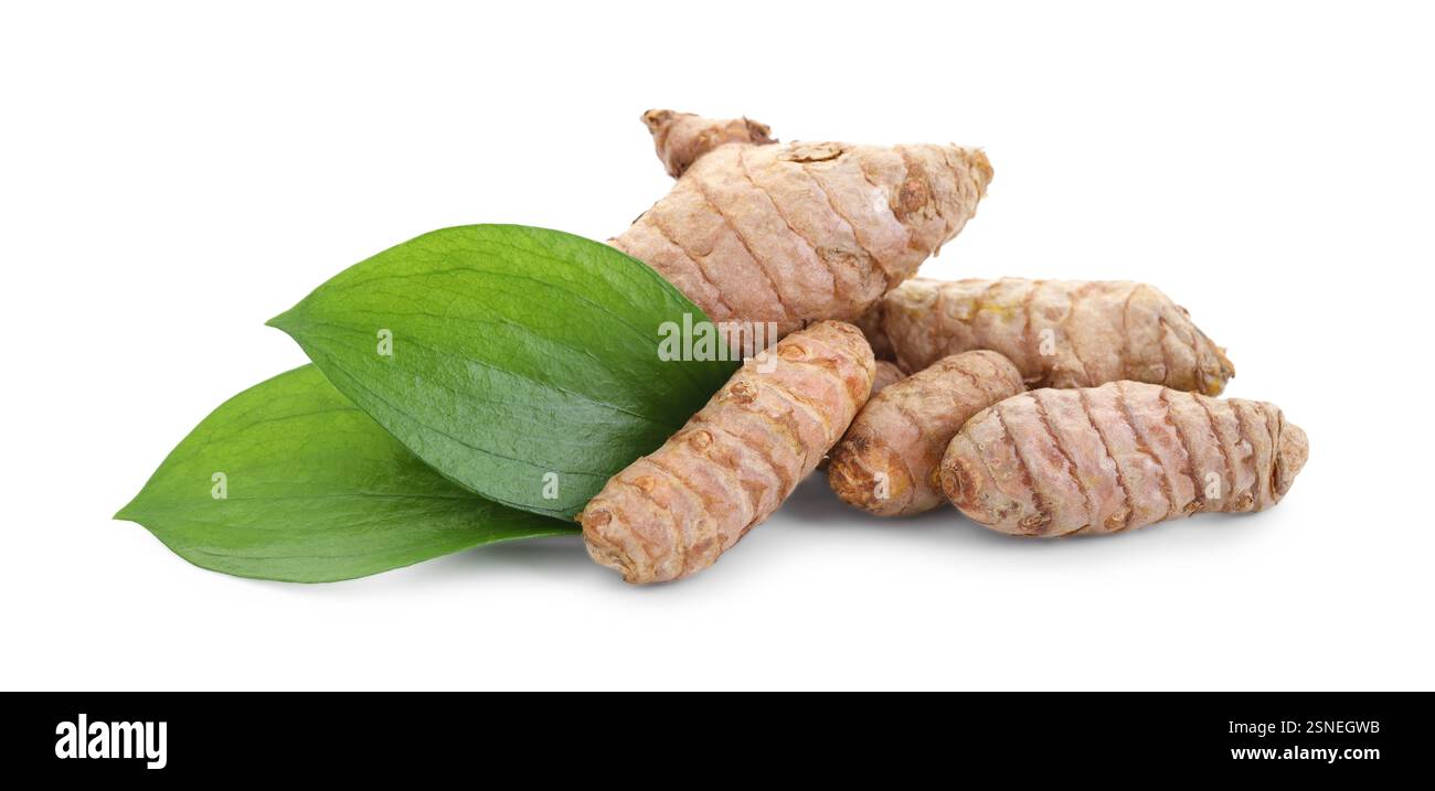 Raw turmeric roots and green leaves isolated on white Stock Photo - Alamy
