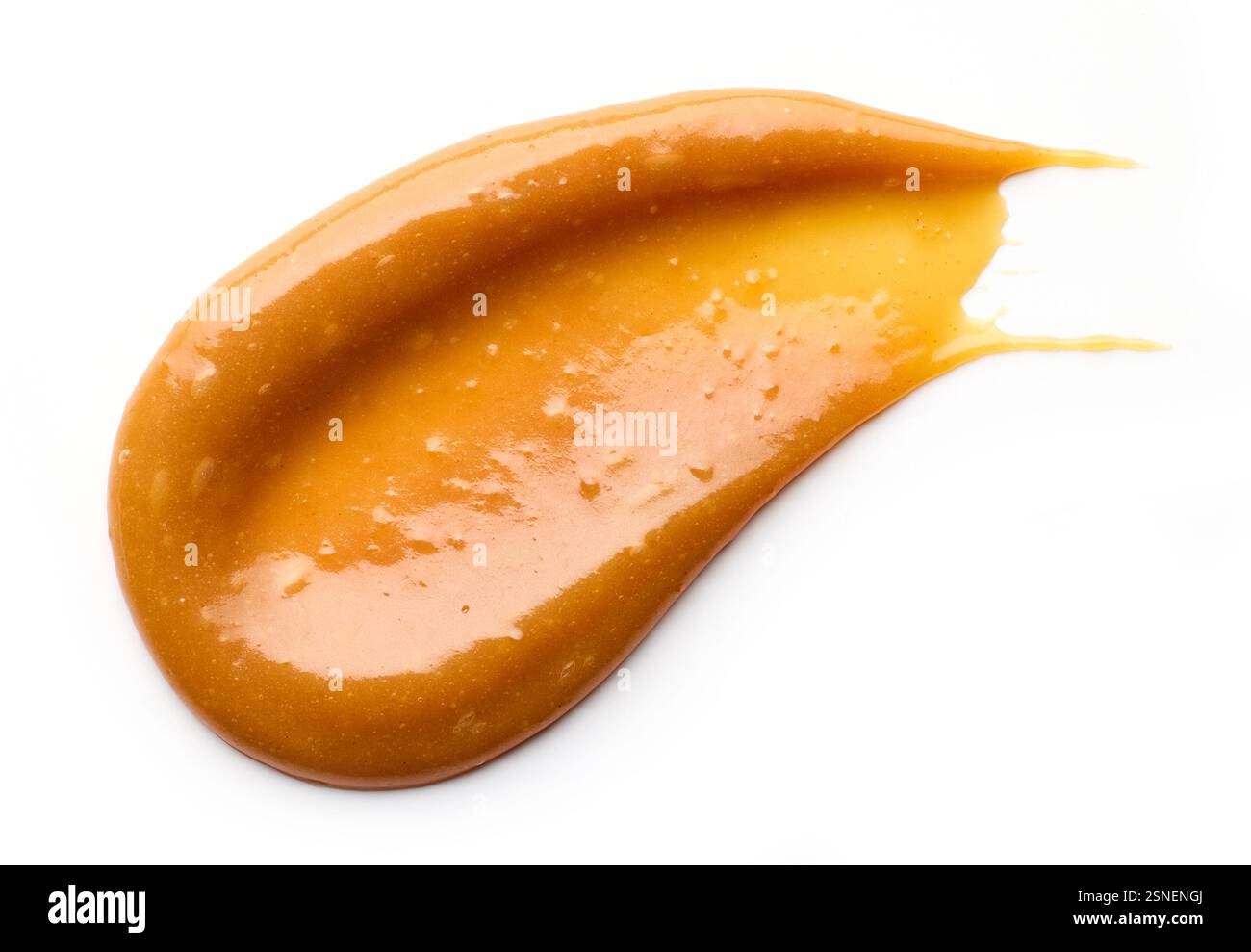 Smear of tasty caramel paste on white background, top view Stock Photo ...