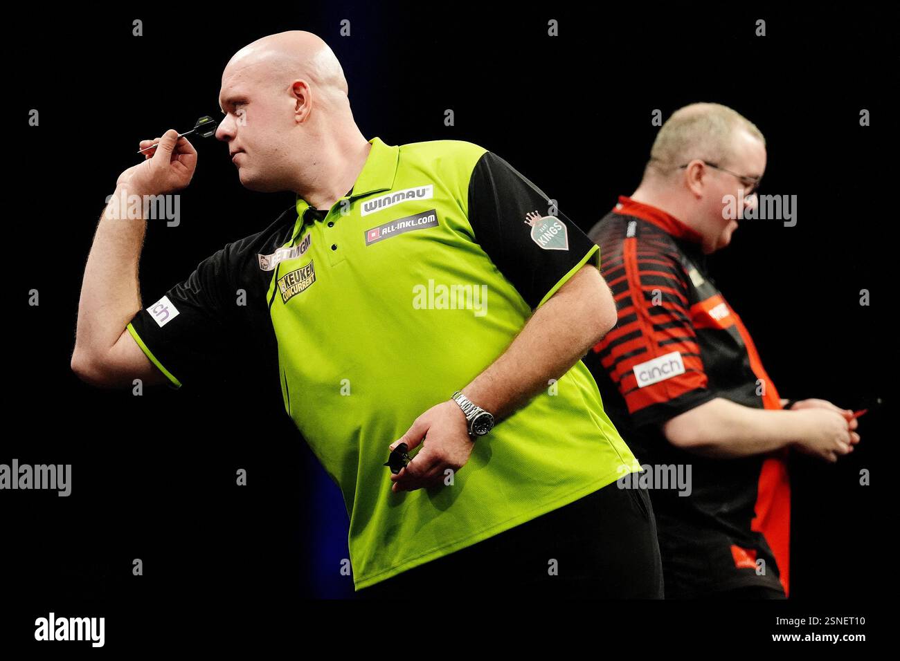 Michael van Gerwen (left) in action during his match against Stephen ...