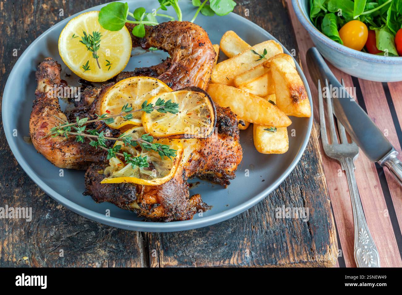 Roasted spatchcock poussin with potato chips Stock Photo - Alamy