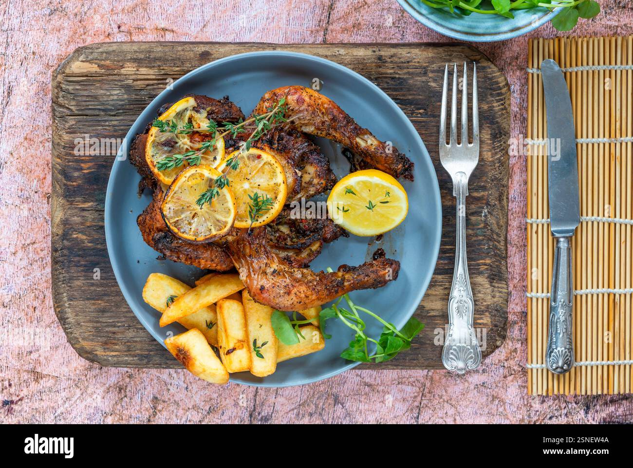 Roasted spatchcock poussin with potato chips Stock Photo - Alamy