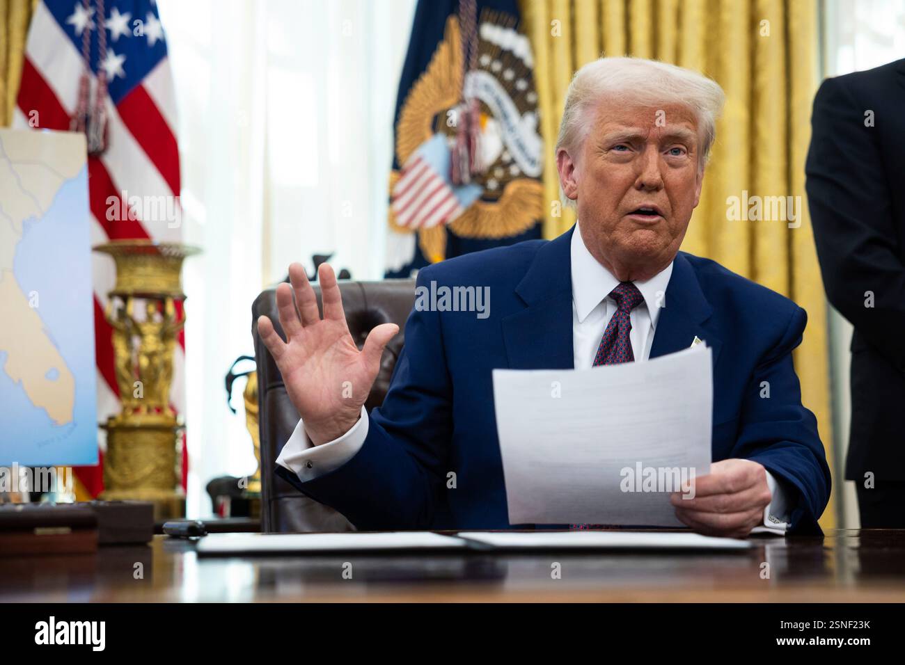 President Donald Trump signs executive orders in the Oval Office at the ...