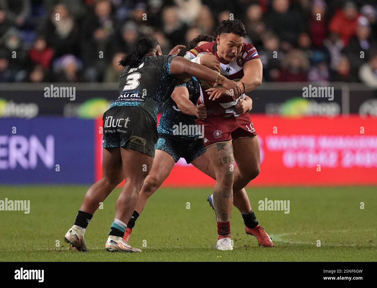 Wigan Warriors' Tyler Dupree (right) is tackled by Leigh Leopards' Tesi ...