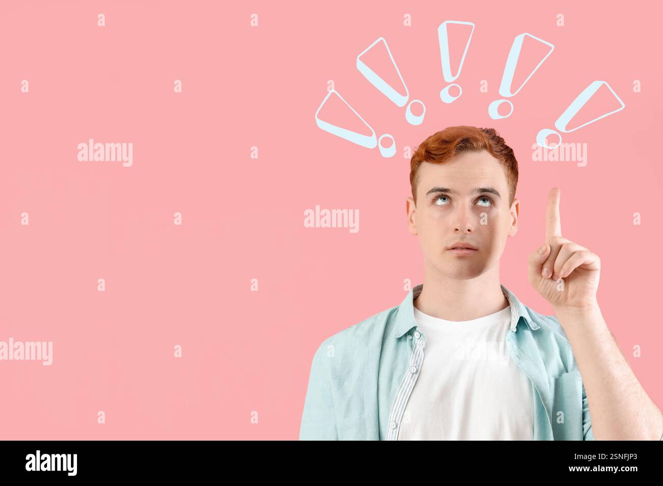 Thoughtful young man with raised index finger and exclamation marks on ...