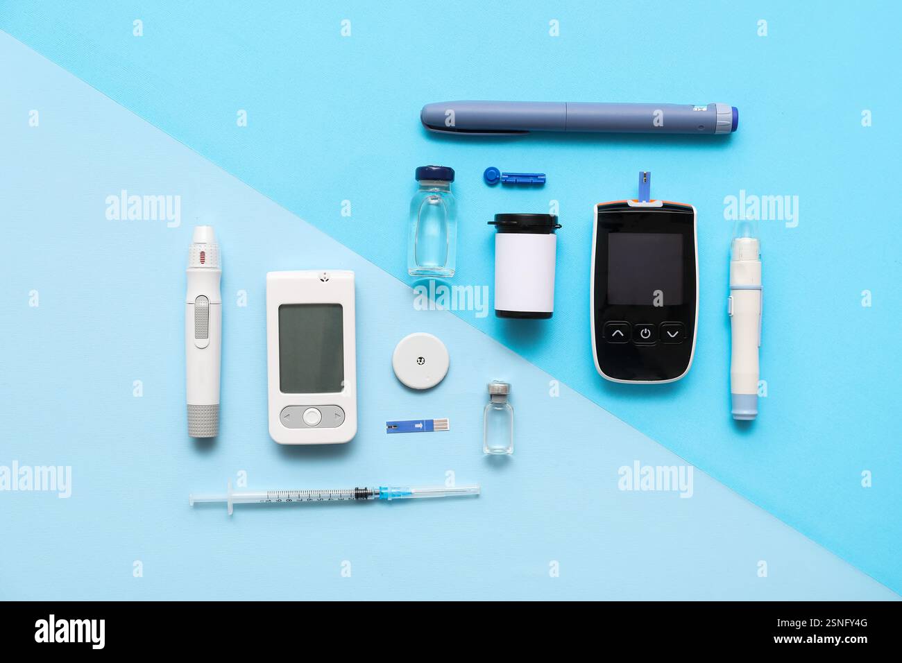 Modern glucometers with lancet pens, insulin ampules and syringe on ...