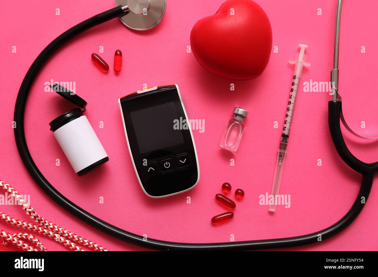 Modern glucometer with insulin ampule, syringe, stethoscope, pills and ...