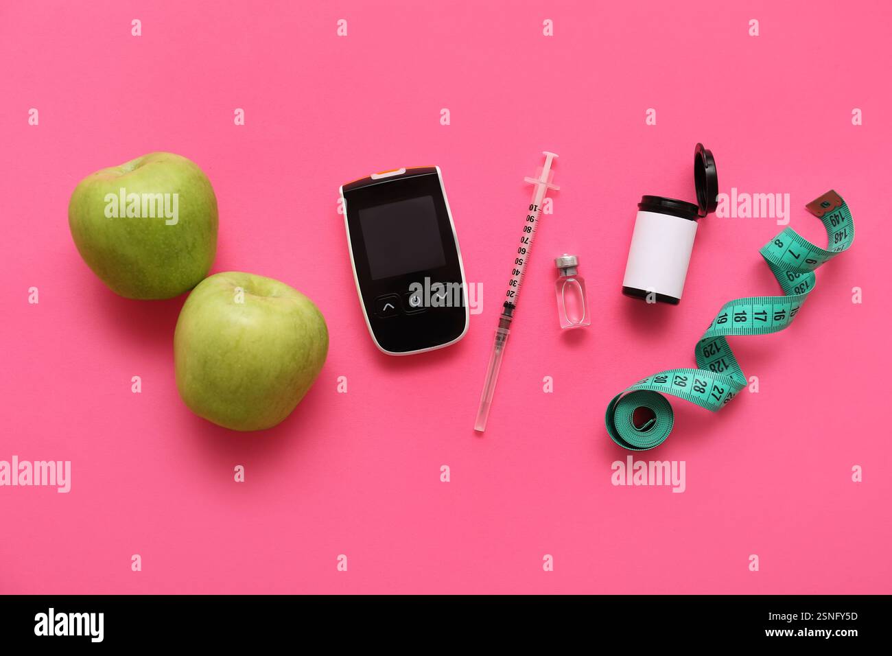 Modern glucometer with syringe, insulin ampule, apples and measuring ...