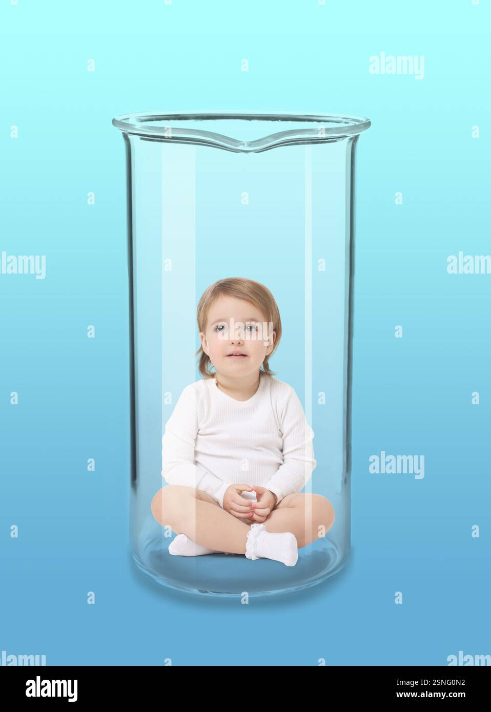 Cute baby in glass beaker on light blue gradient background. In vitro ...