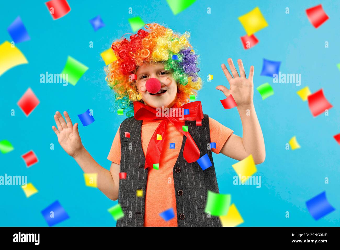 Happy boy dressed like clown under falling confetti on light blue ...