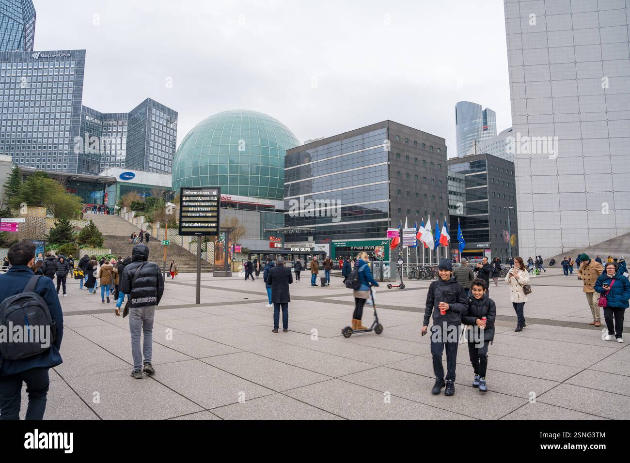 Busy day at La Defense's lively square with modern architecture Stock ...