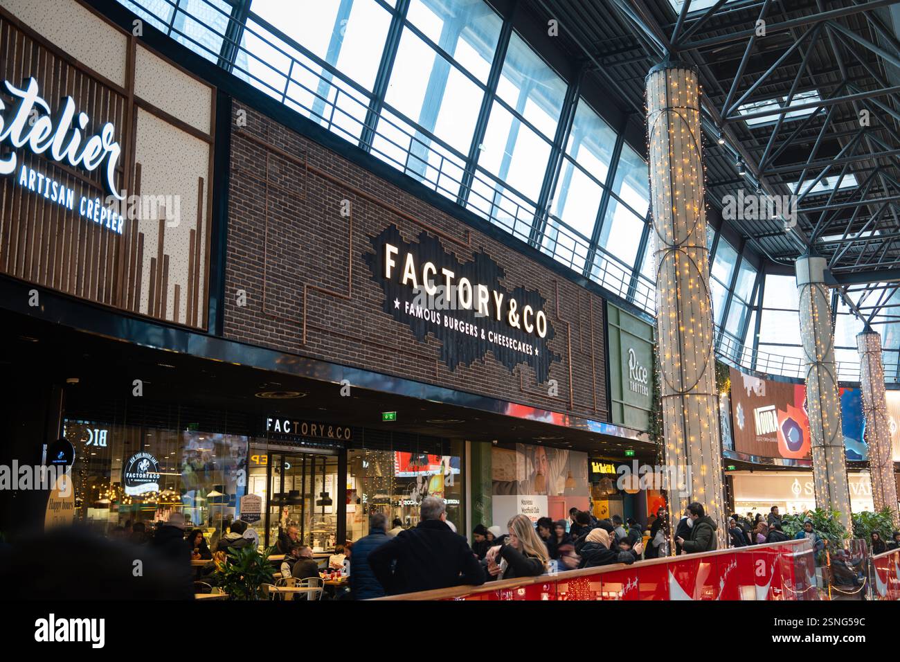 Bustling food court at Factory and Co with festive lights and diverse ...