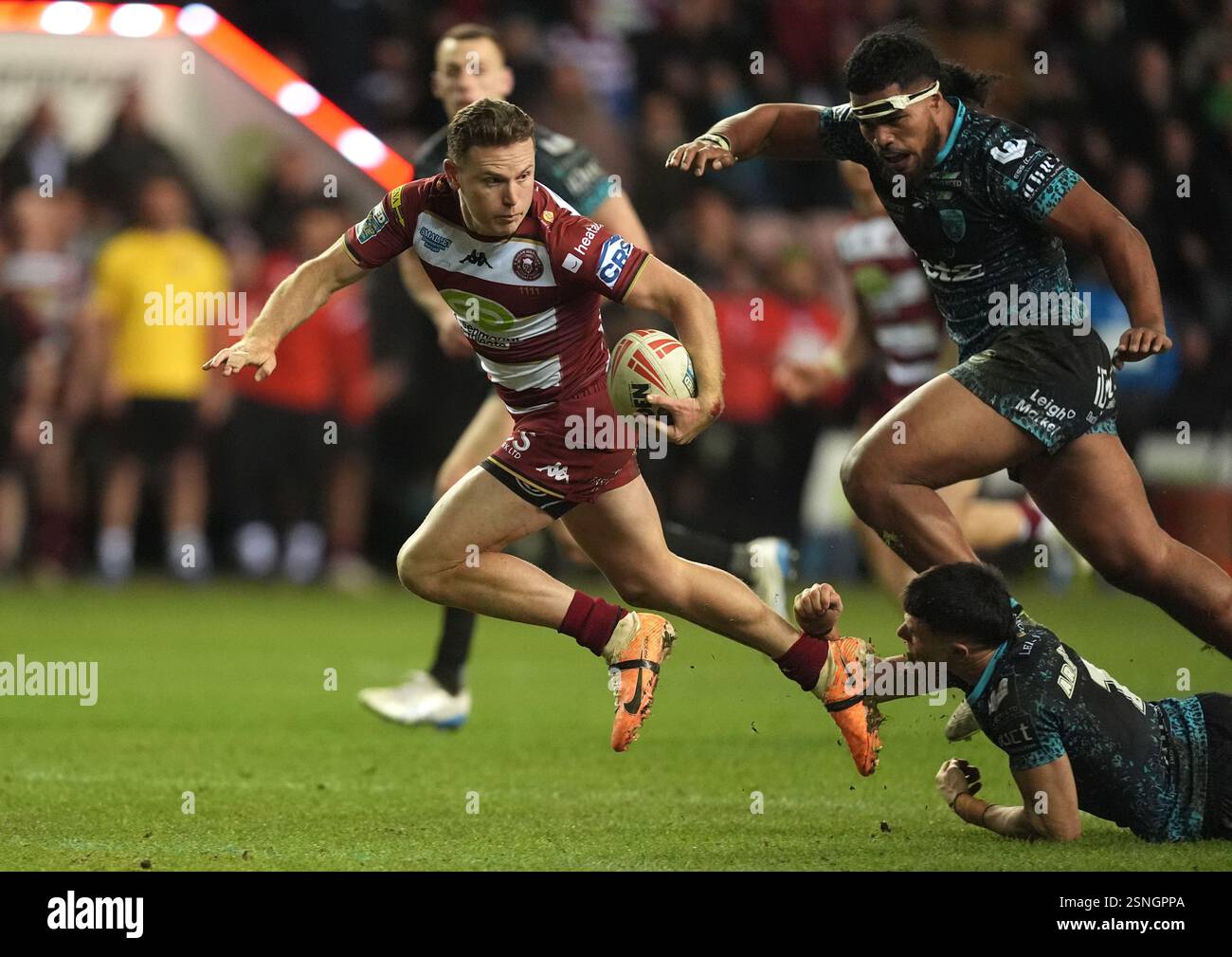 Wigan Warriors' Jai Field (left) in action with Leigh Leopards' David ...