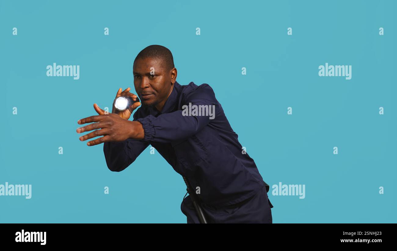 Security guard preventing criminal activity turning on flashlight after ...