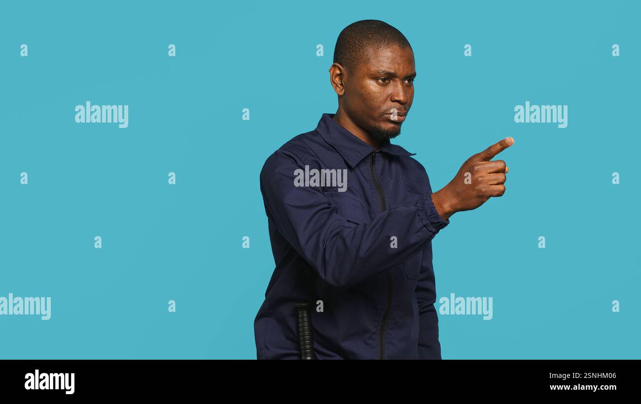 Portrait of security agent pointing finger at people, warning them ...