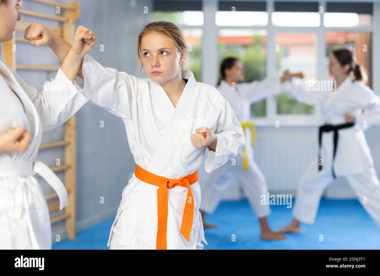 Girl opponent punches enemy with feet and hands, using all strength ...