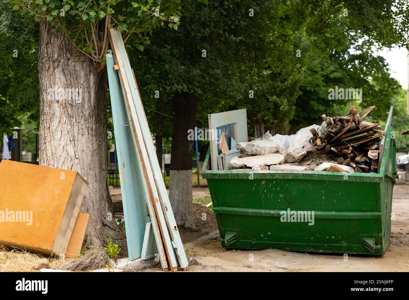 Industrial waste container filled with construction waste, located in ...