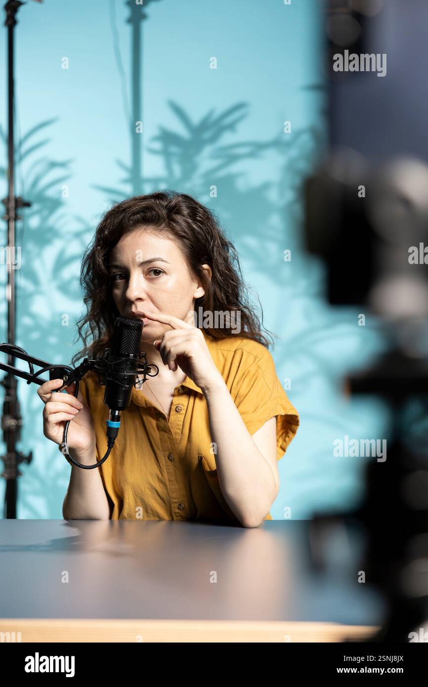 Content creator recording livestream in studio, using mobile phone on ...