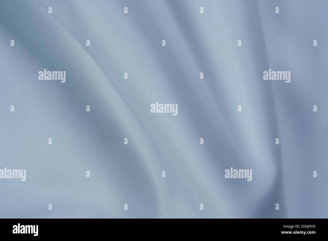 Close-up of soft white fabric with gentle folds creating a swirl ...