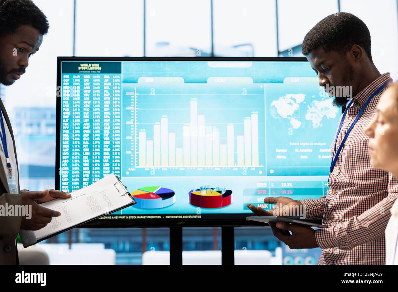 Team of workers presenting infographics and sales numbers on an ...