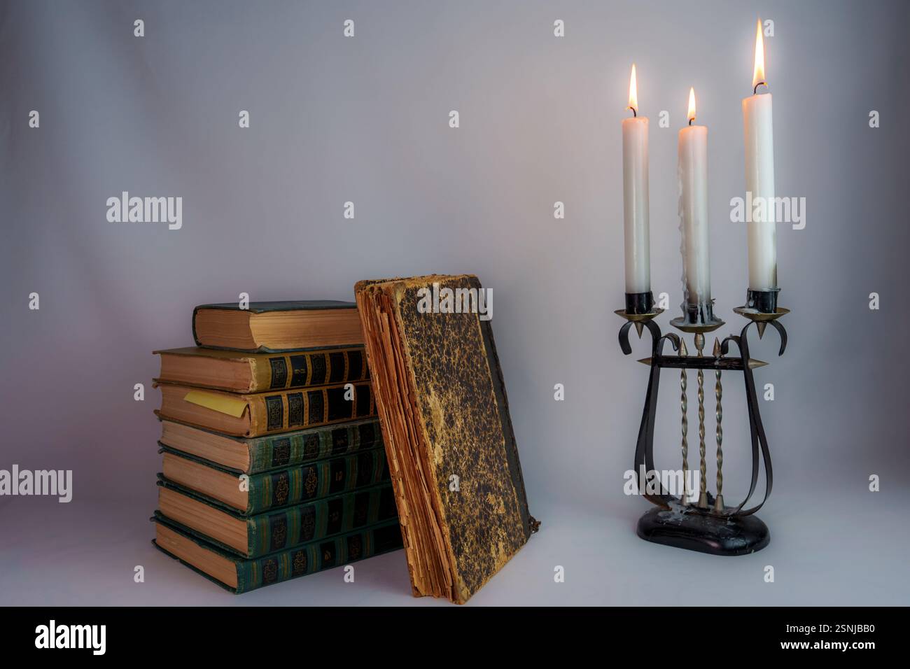 A stack of vintage hardcover books with one book partially open, next ...