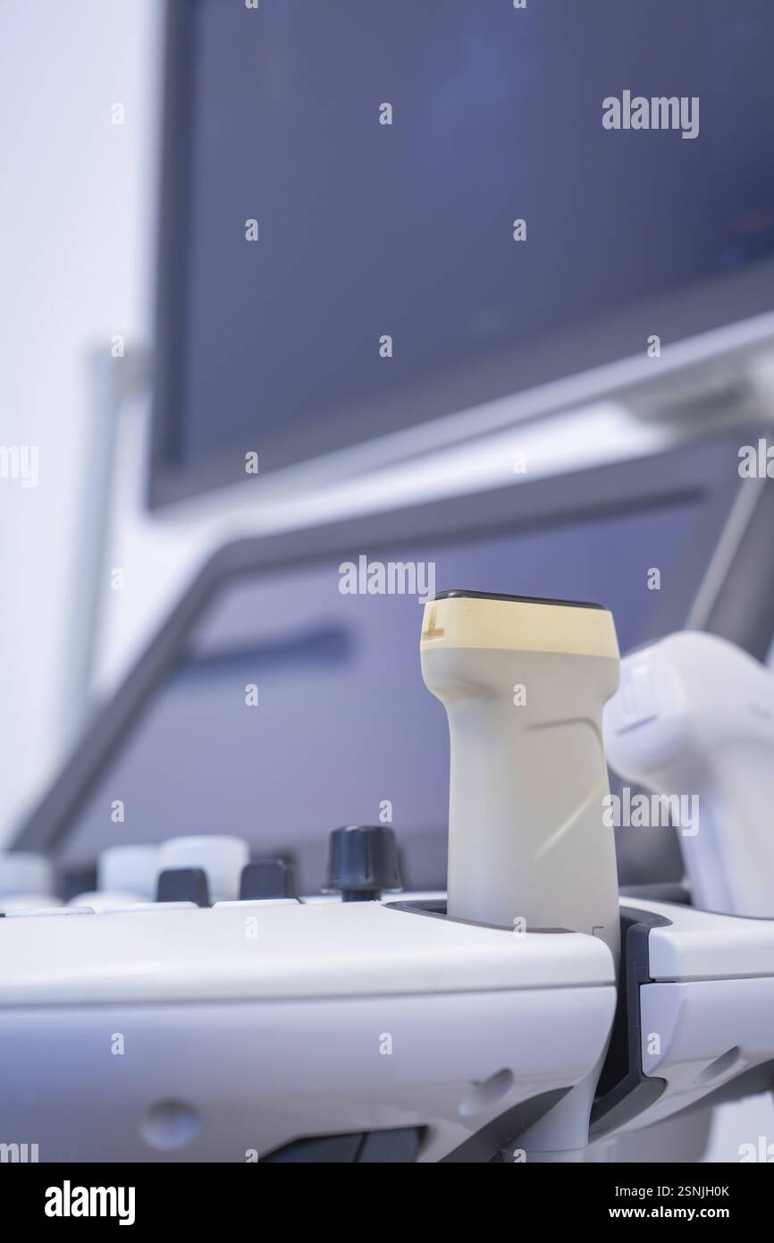 Medical ultrasound probe in front of a screen in a clinical environment ...